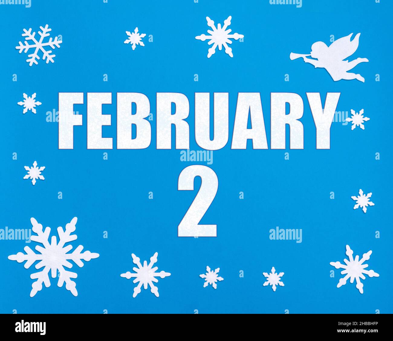 February 2nd. Winter blue background with snowflakes, angel and a ...