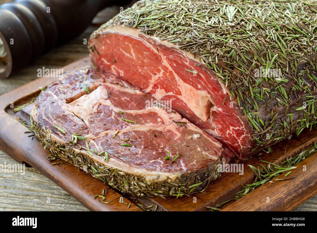 raw ribeye on wood background. Close-up of marinated beef ribeye with ...