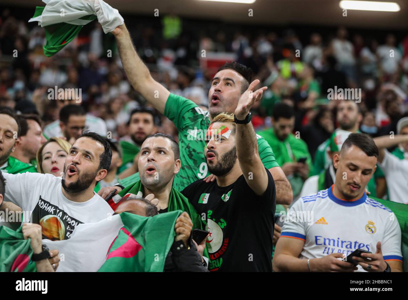 Al Khor, Qatar. 18th Dec, 2021. Algerian fans cheer in the stands ...