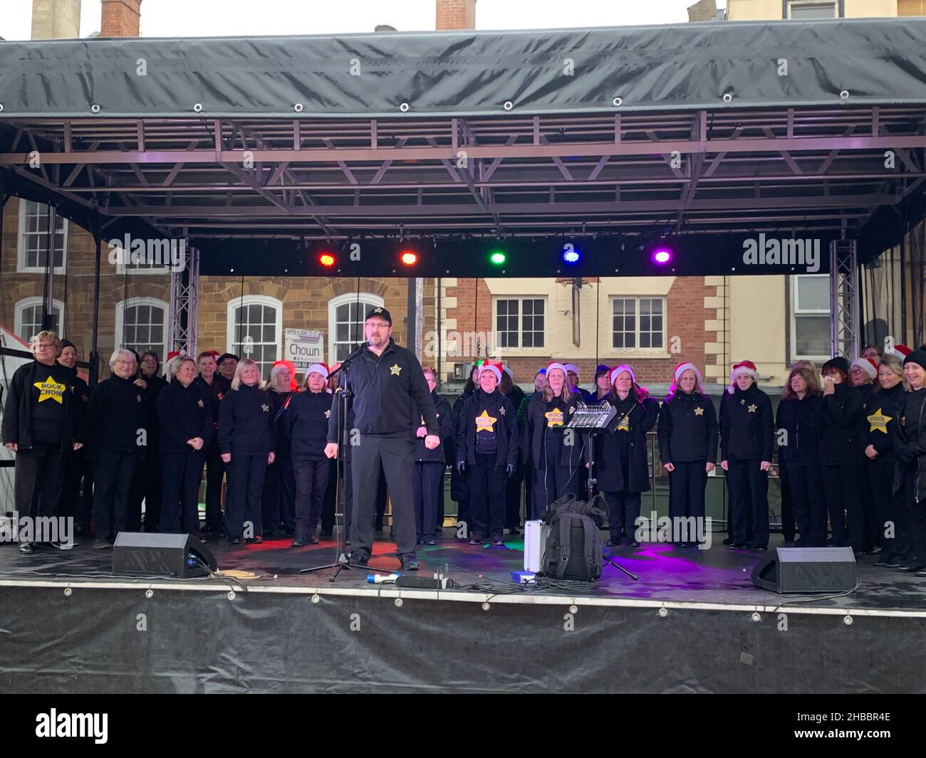 Market Square Northampton UK Rock Choir singing songs Christmas hats ...