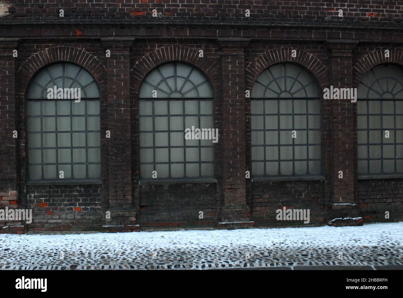 brick wall with arched windows in winter setting Stock Photo - Alamy