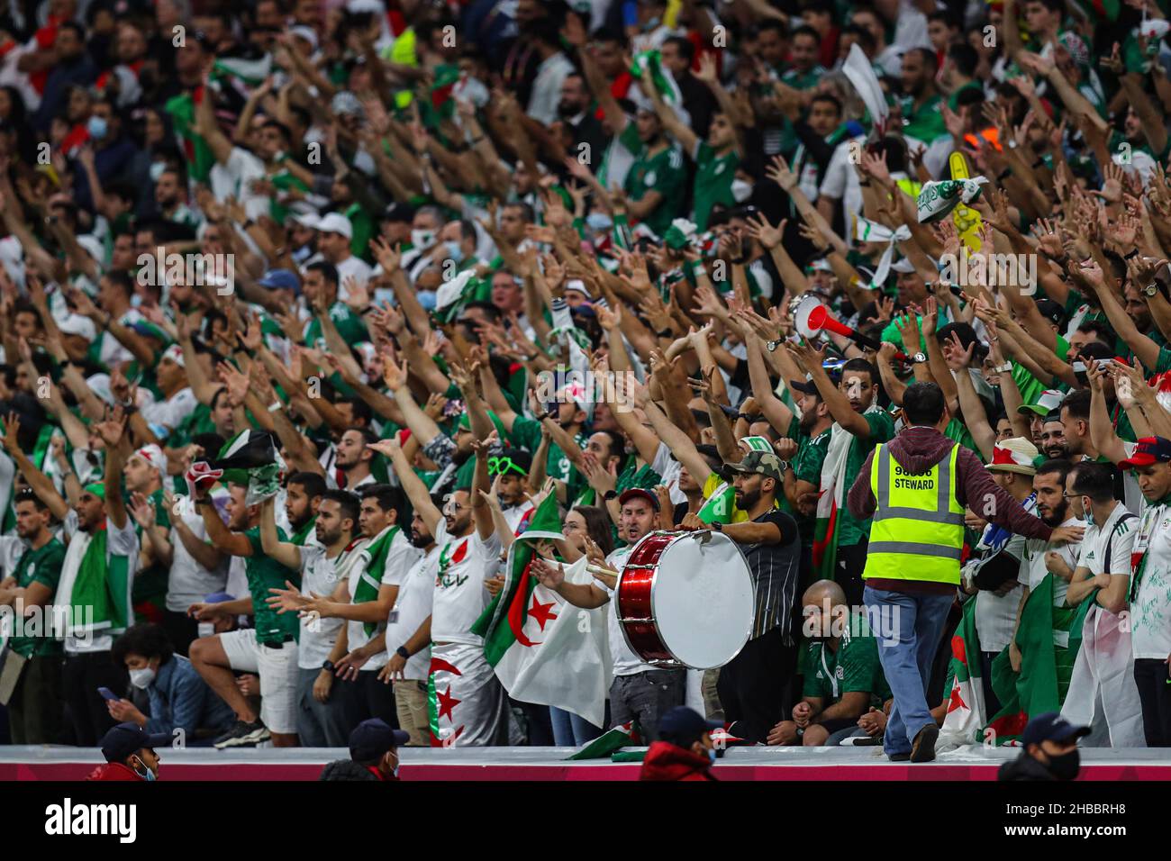Al Khor, Qatar. 18th Dec, 2021. Algerian fans cheer in the stands ...