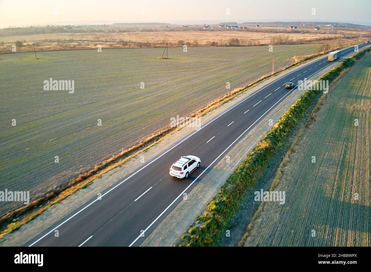 Aerial view of intercity road with fast driving cars at sunset. Top ...