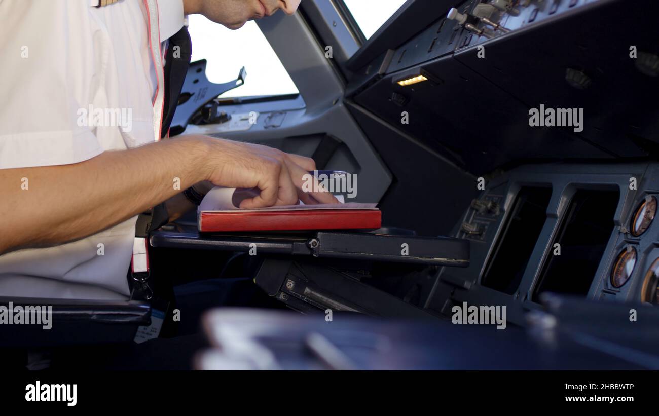 Rear view of pilot operating controls of corporate jet. the pilot ...