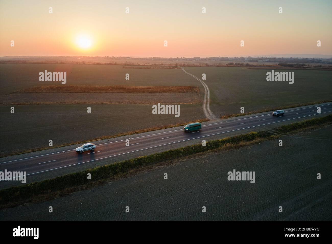 Aerial view of intercity road with fast driving cars at sunset. Top ...