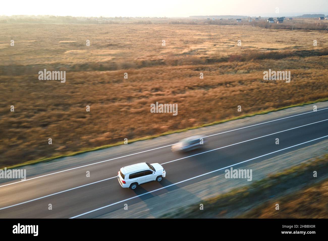 Aerial view of intercity road with fast driving cars at sunset. Top ...