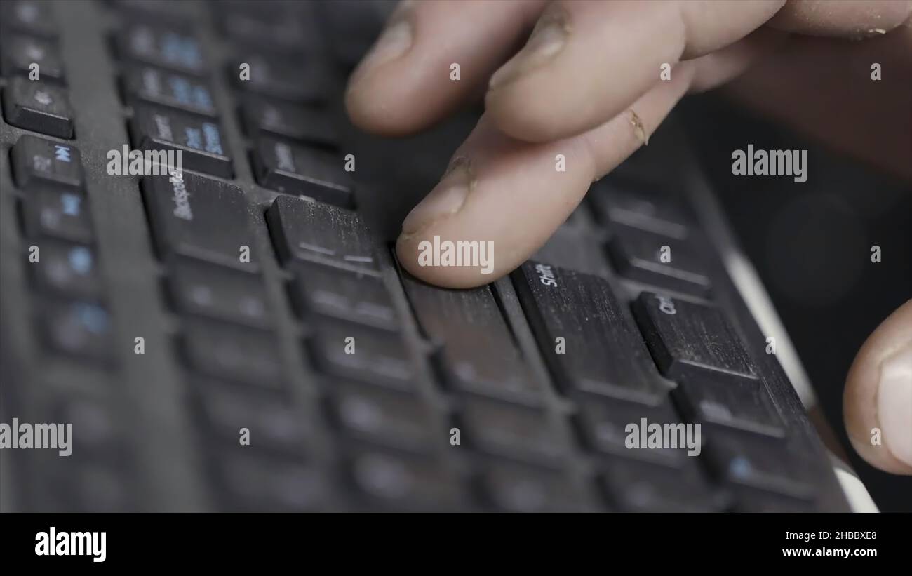 Close-up of finger over black laptop keys pressing enter button ...
