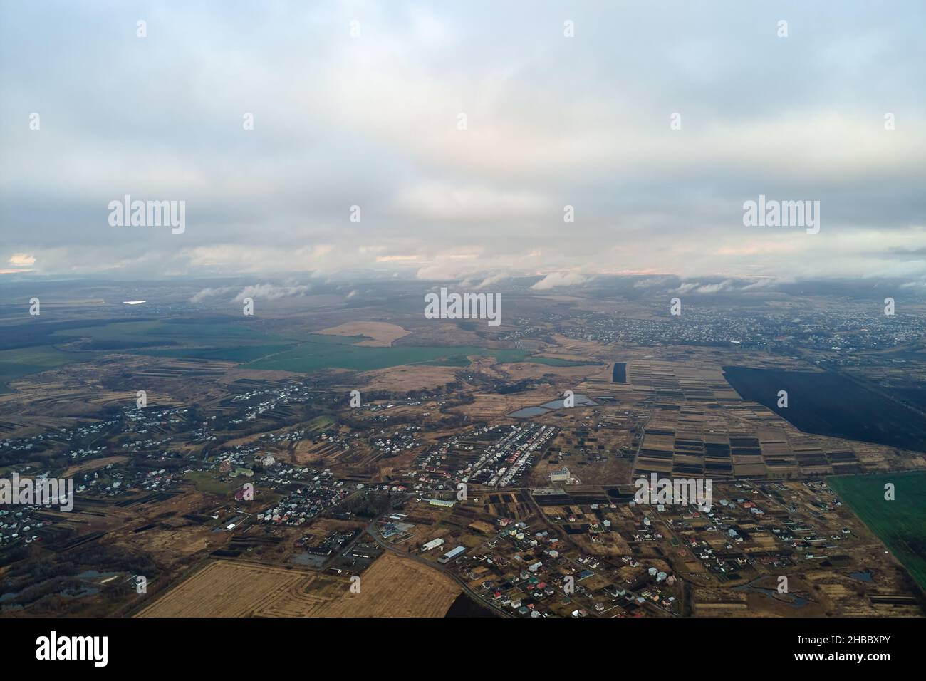 Aerial view of rural homes and distant high rise apartment buildings in ...