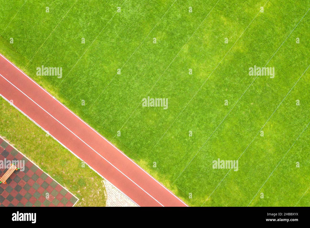 Aerial view of surface of green freshly cut grass on football stadium ...