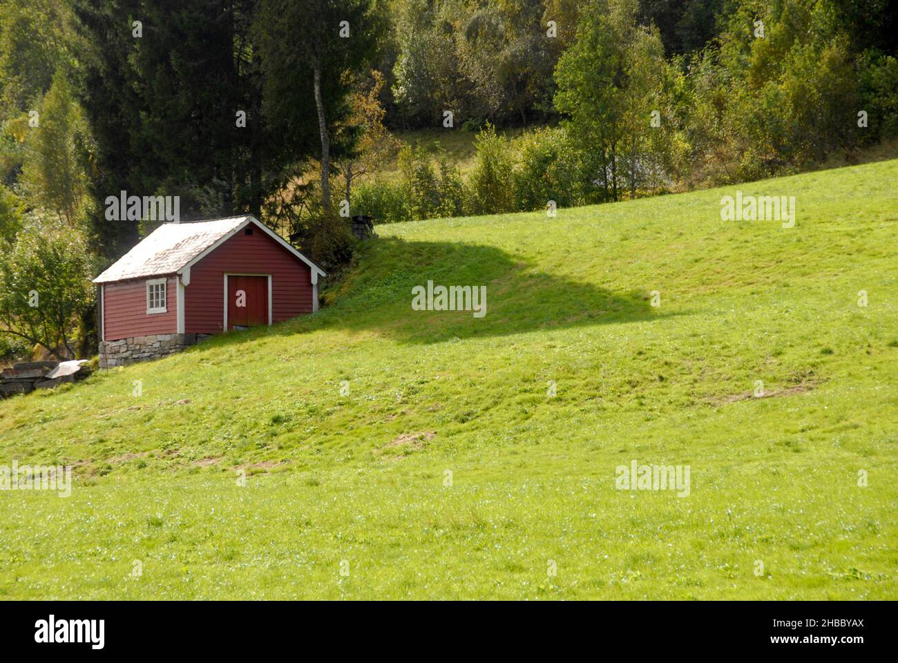 Small brown wooden hut built into side of steep hill, Norway Stock ...