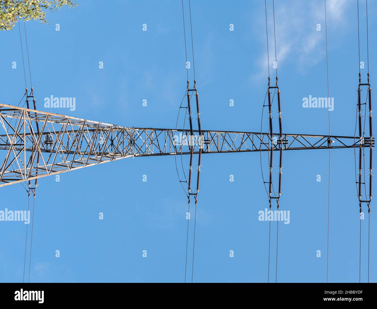 Electricity pylon in the middle from below under a blue sky Stock Photo ...