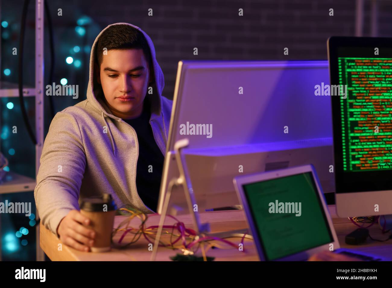Hacker in dark room with computers Stock Photo - Alamy