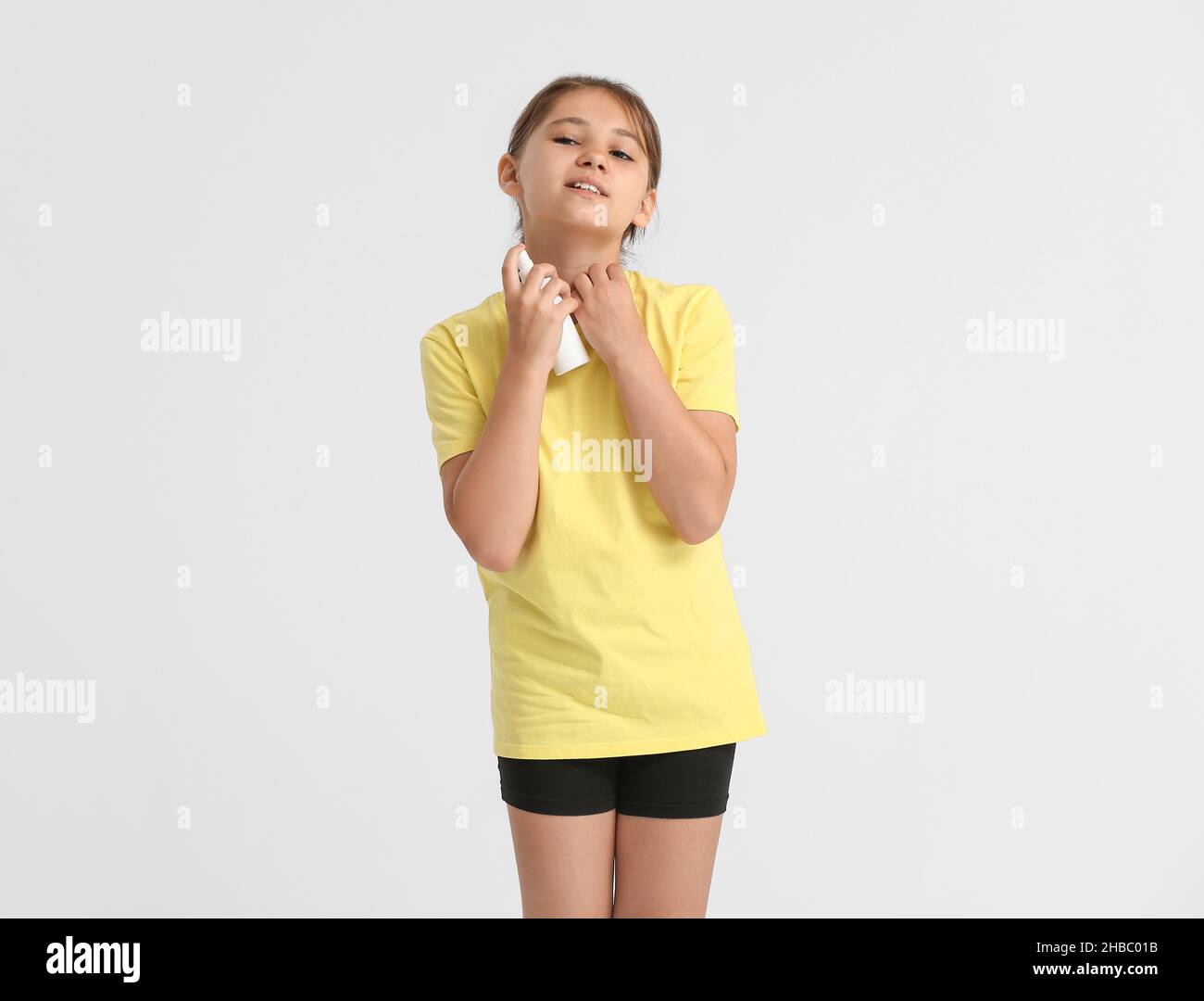 Little girl with mosquito repellent on light background Stock Photo - Alamy