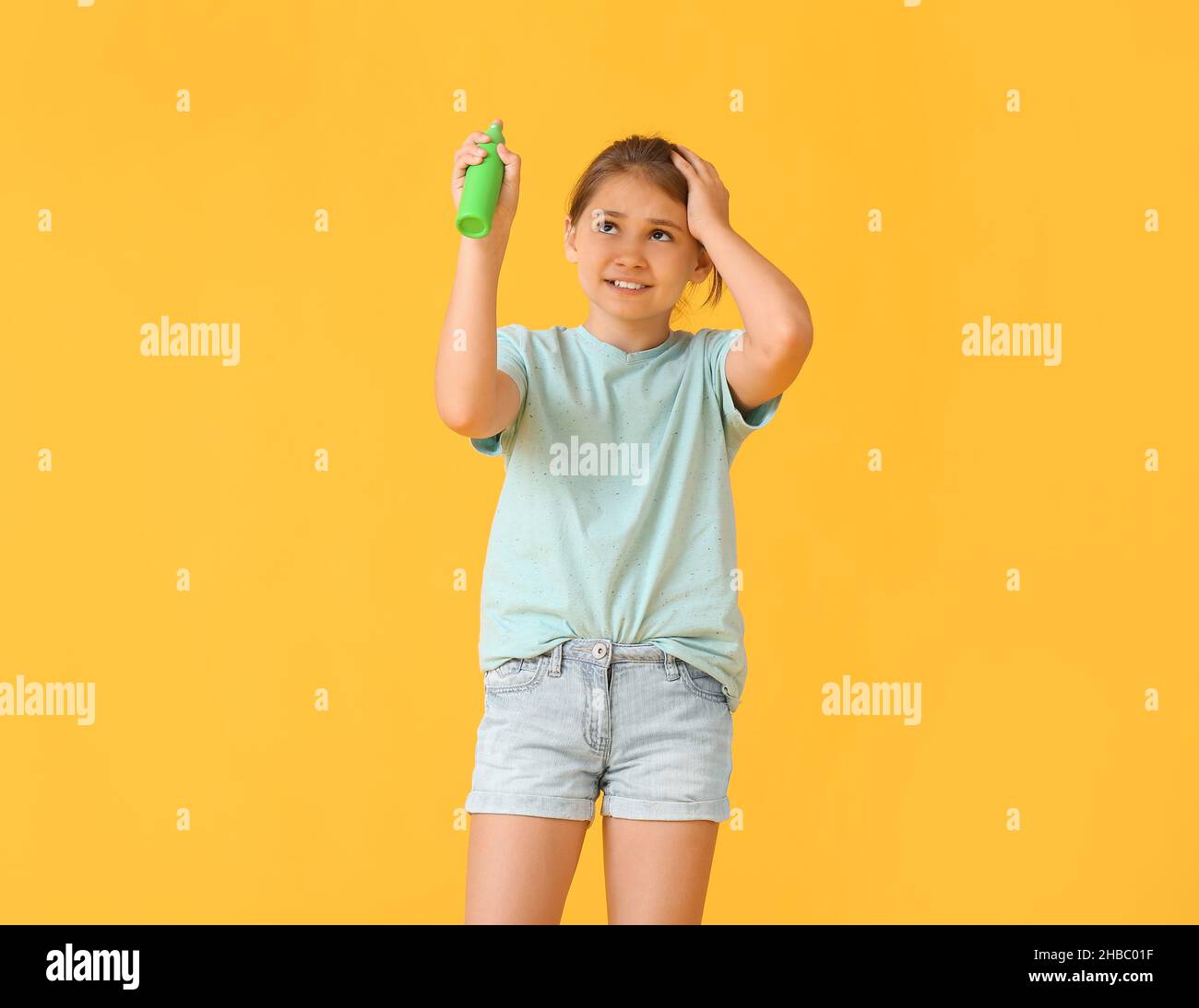 Little girl with mosquito repellent on color background Stock Photo - Alamy