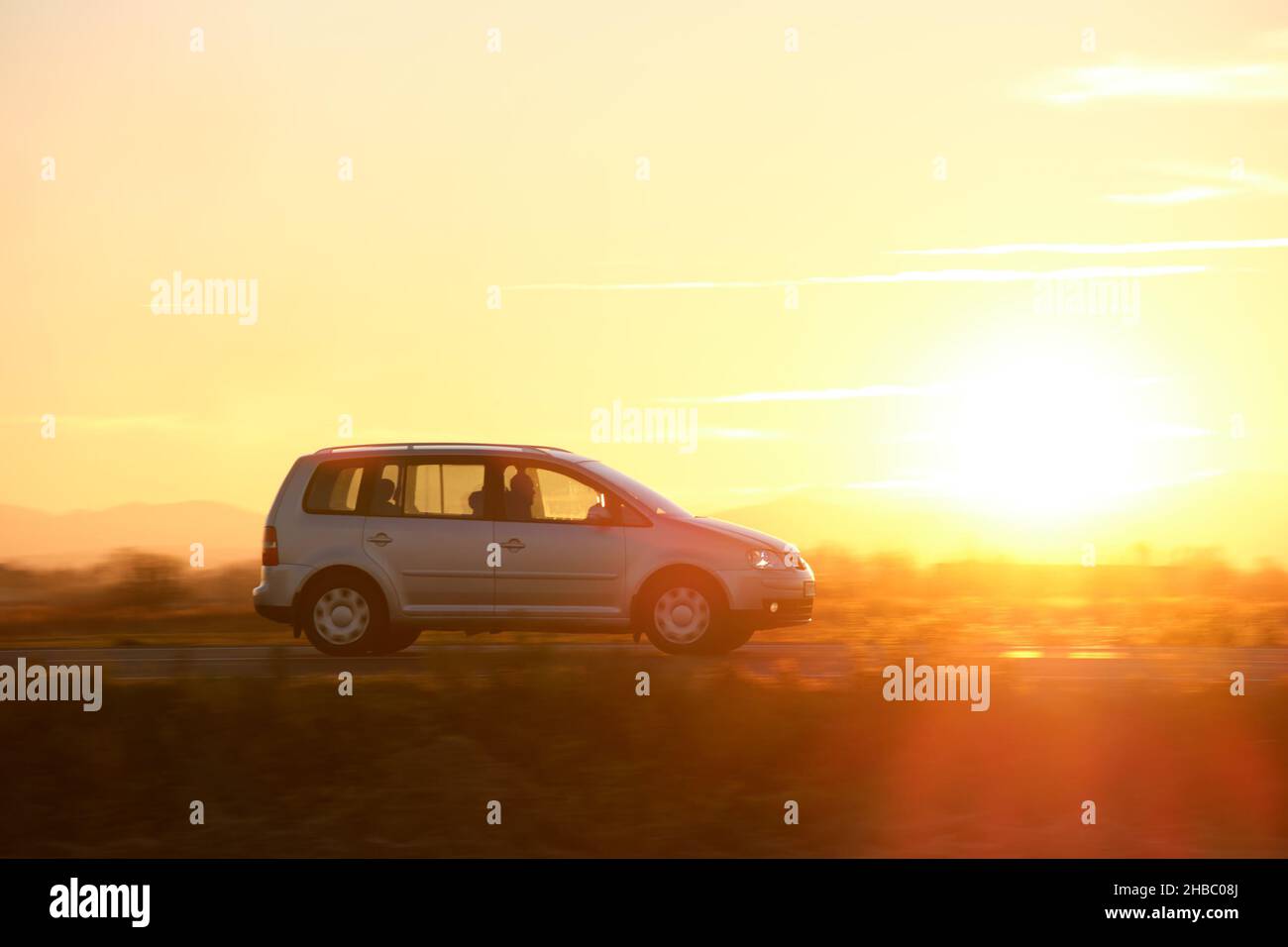 Car driving fast on intercity road at sunset. Highway traffic in ...