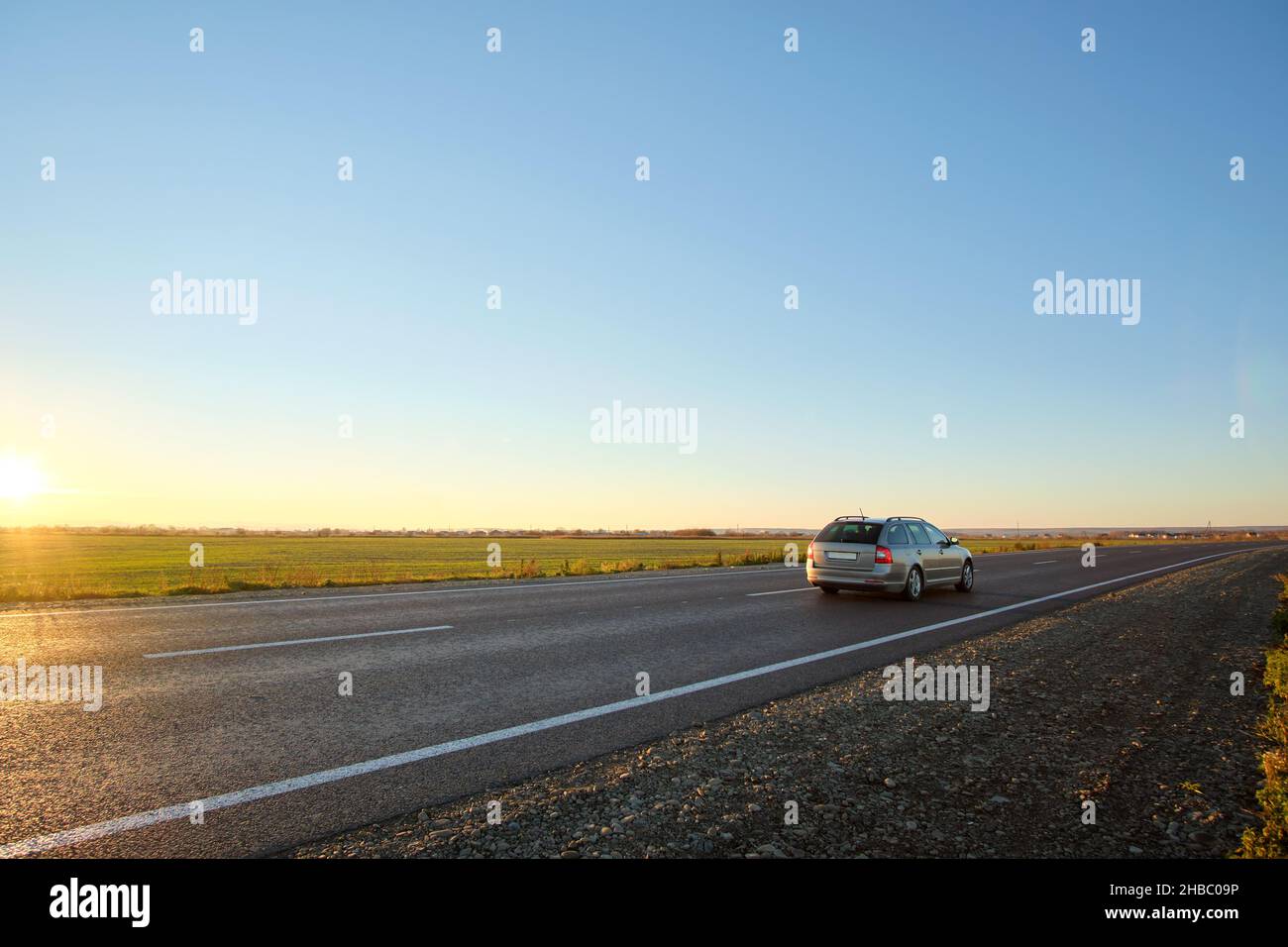 Car driving fast on intercity road at sunset. Highway traffic in ...