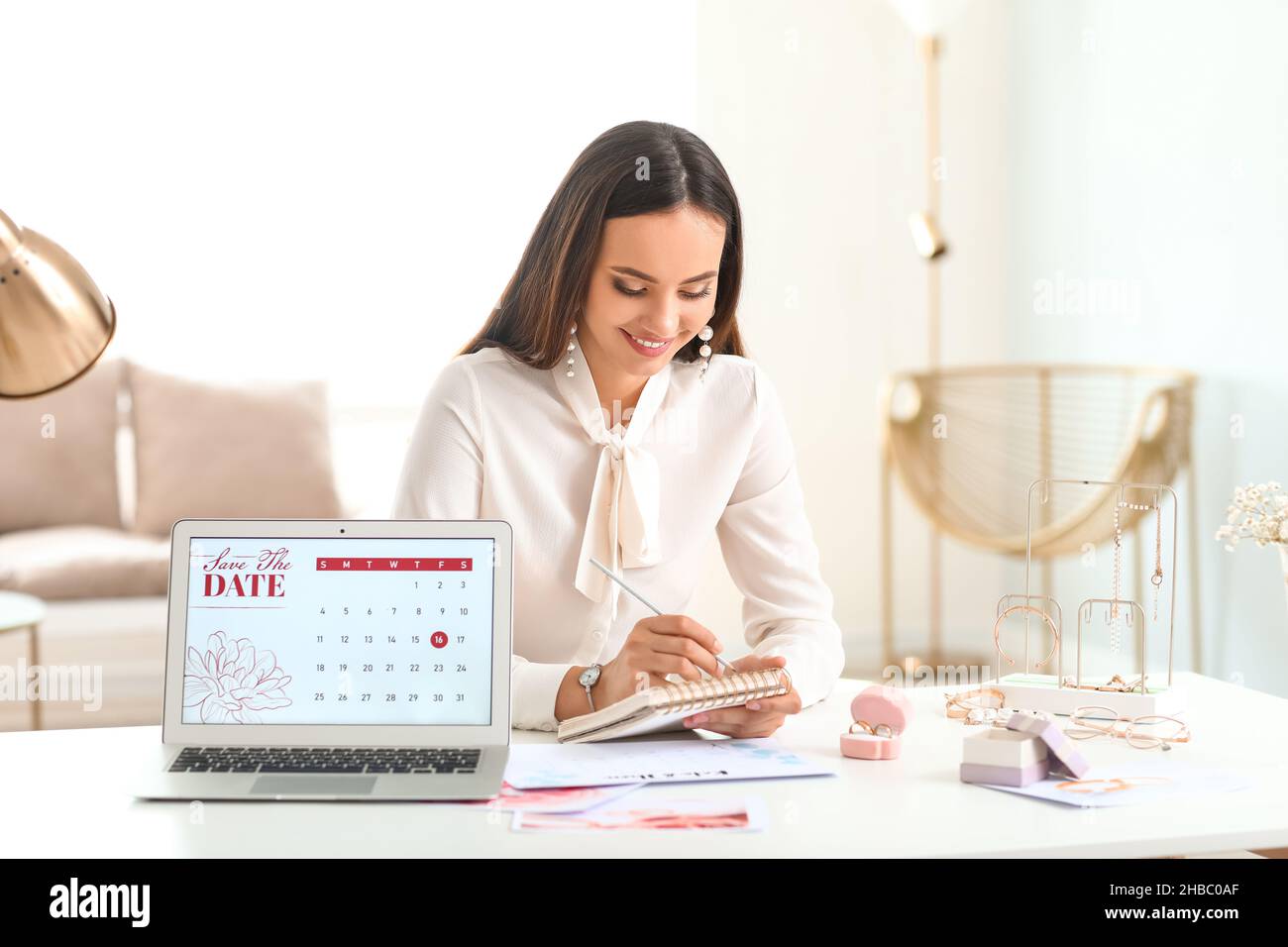 Female wedding planner working in office Stock Photo - Alamy