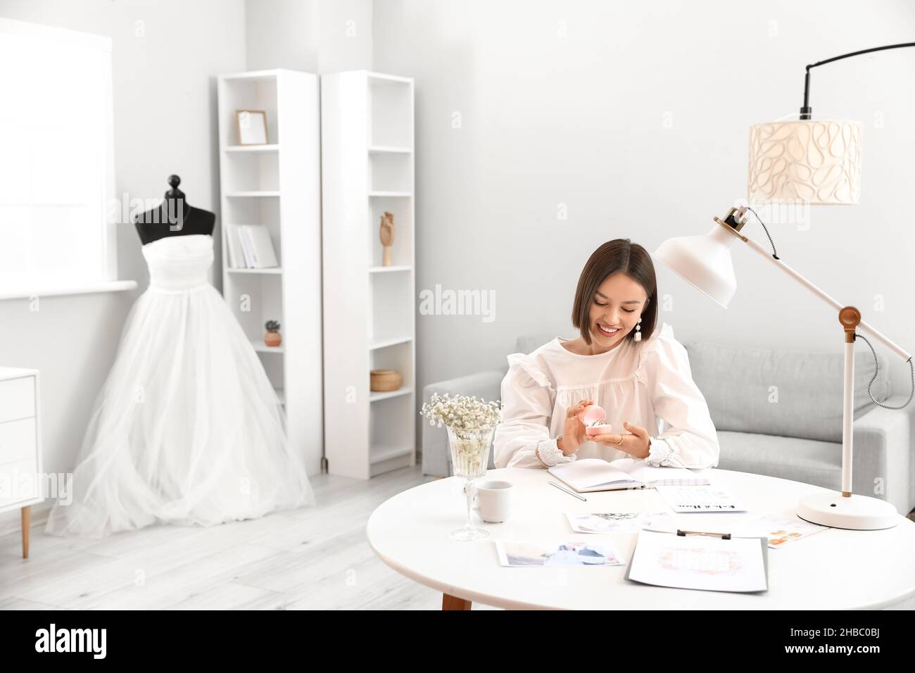 Female wedding planner working in office Stock Photo - Alamy