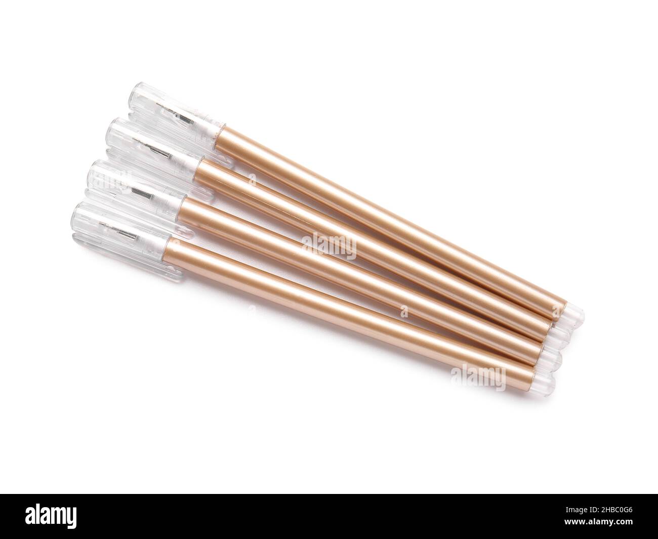 Golden pens on white background Stock Photo - Alamy