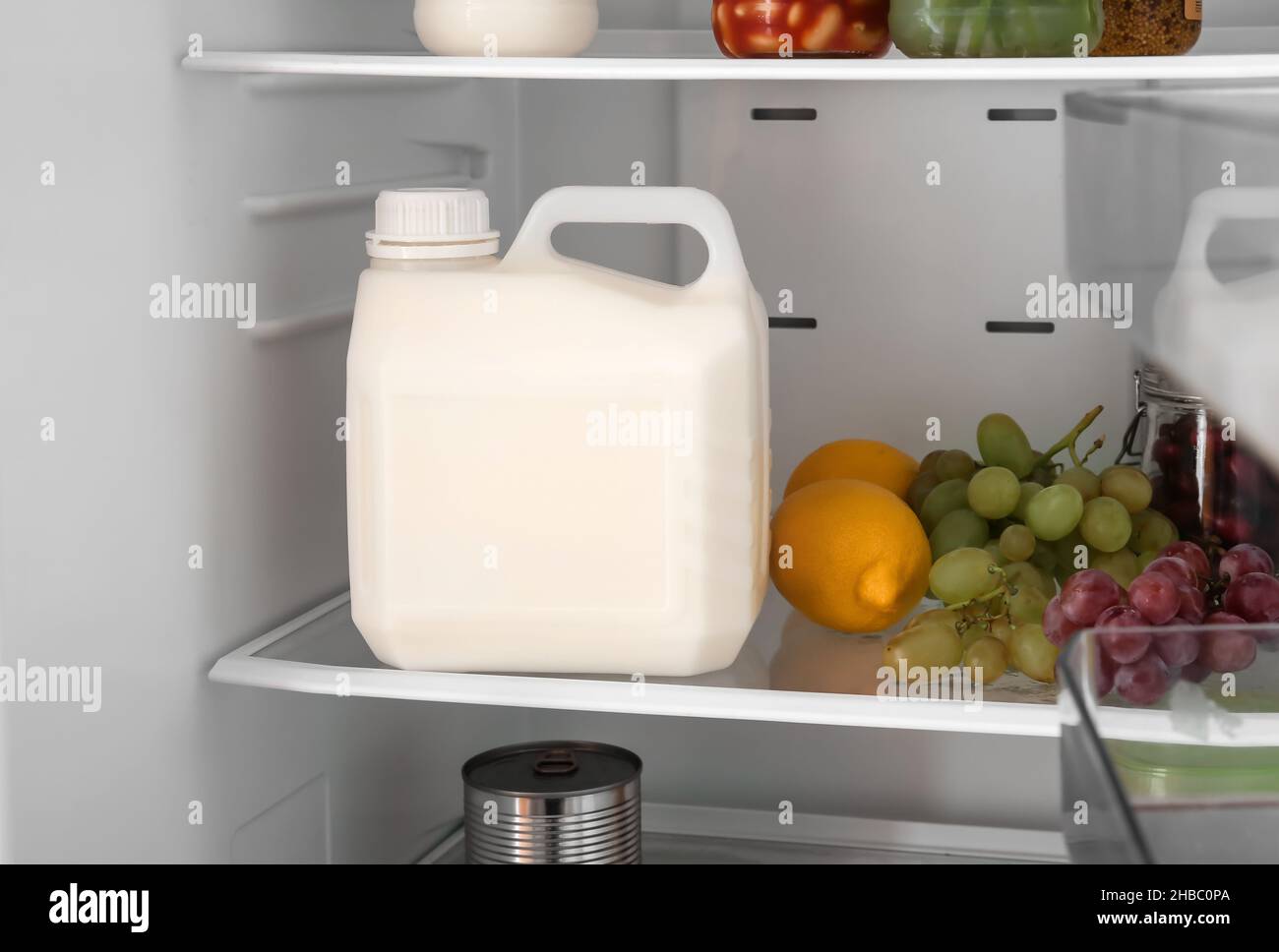Gallon bottle of milk and products on shelf of refrigerator Stock Photo ...