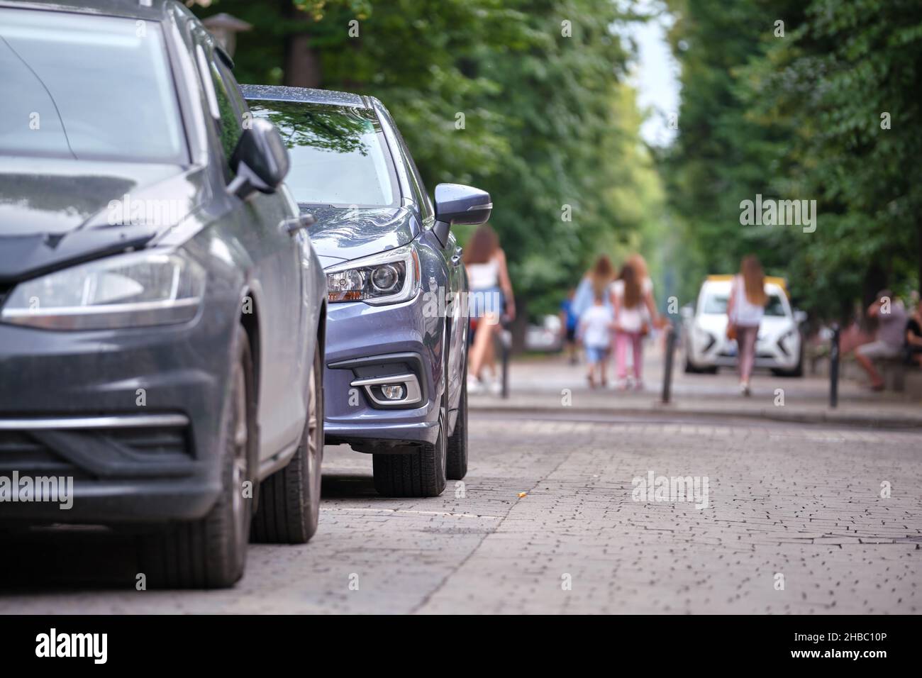 City traffic with cars parked in line on street side Stock Photo - Alamy
