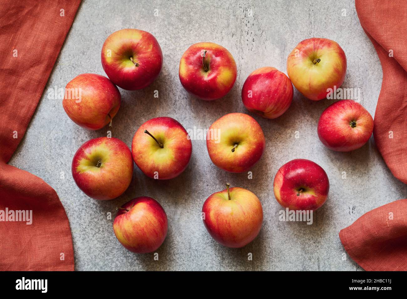 Scattering of fresh ripe red apples in a frame of linen napkins, top ...