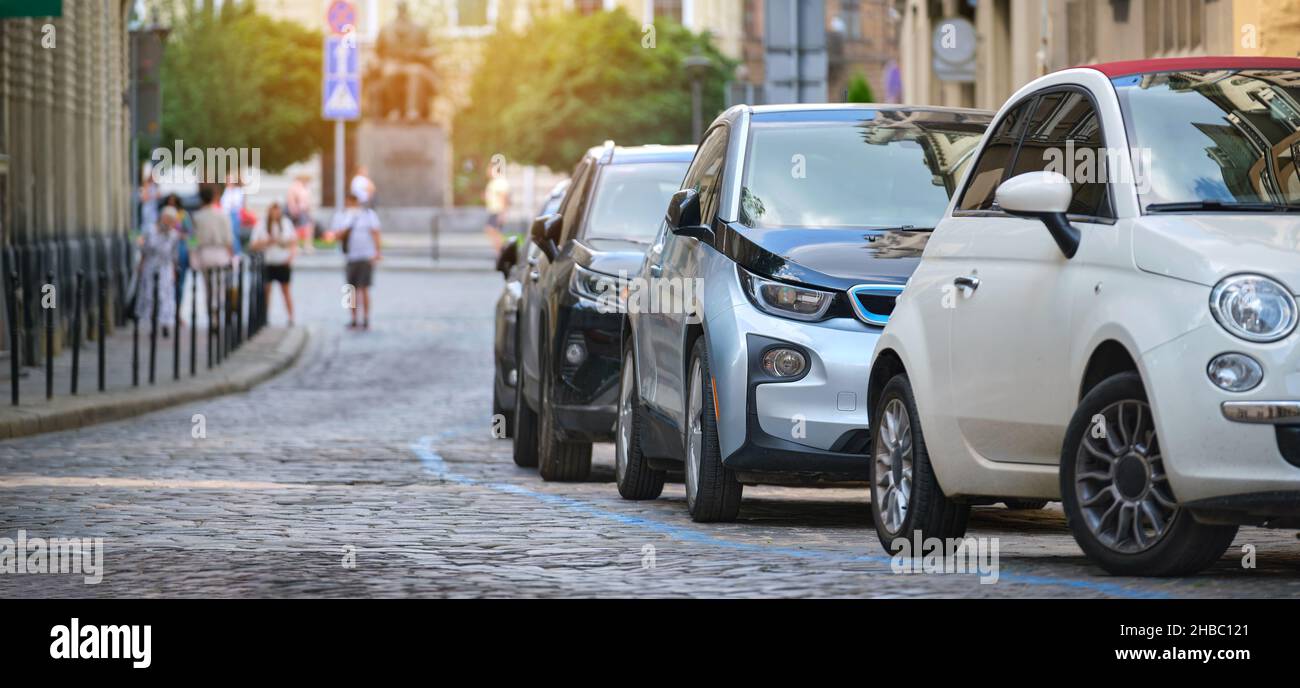 City traffic with cars parked in line on street side Stock Photo - Alamy