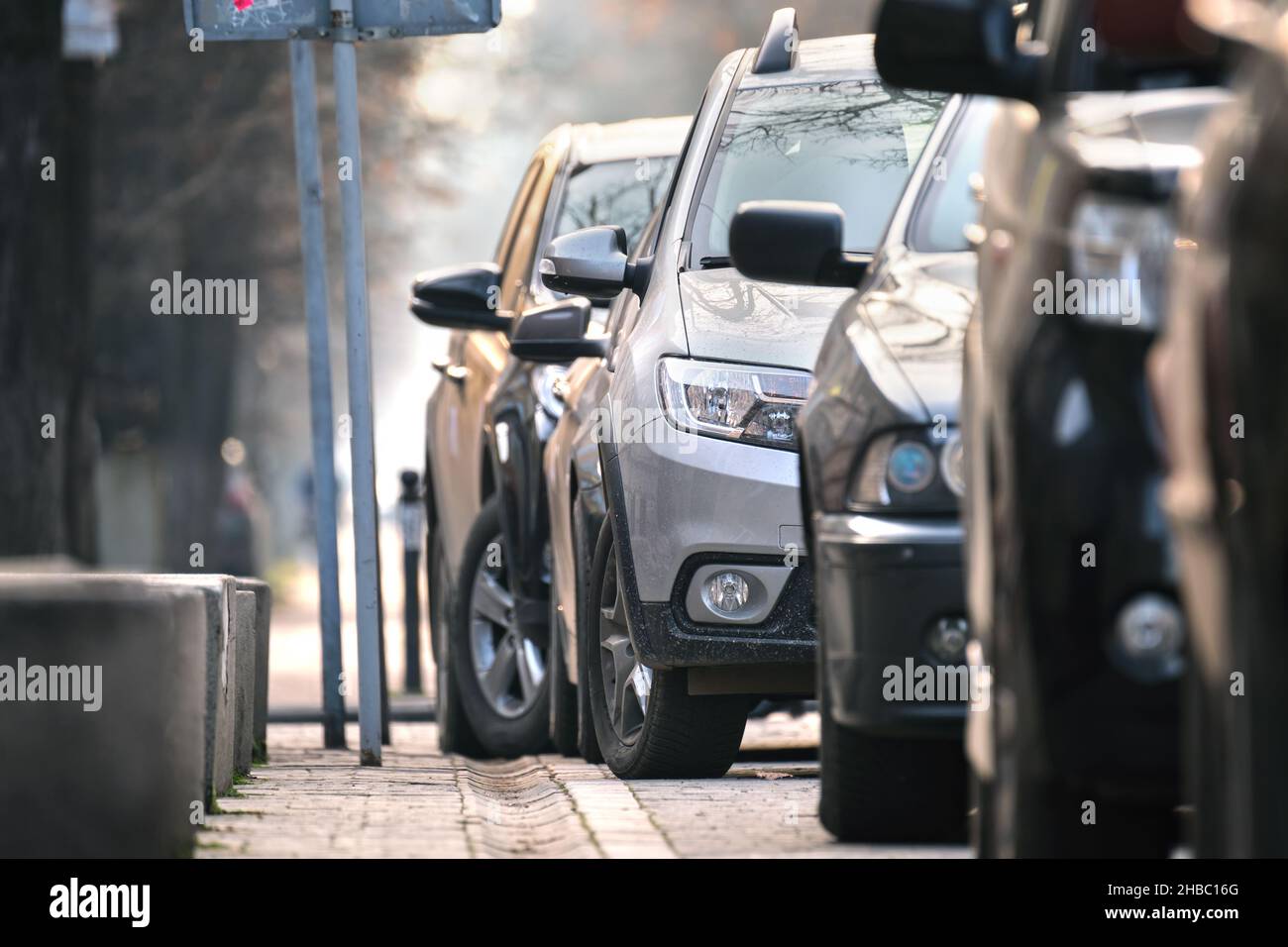 City traffic with cars parked in line on street side Stock Photo - Alamy