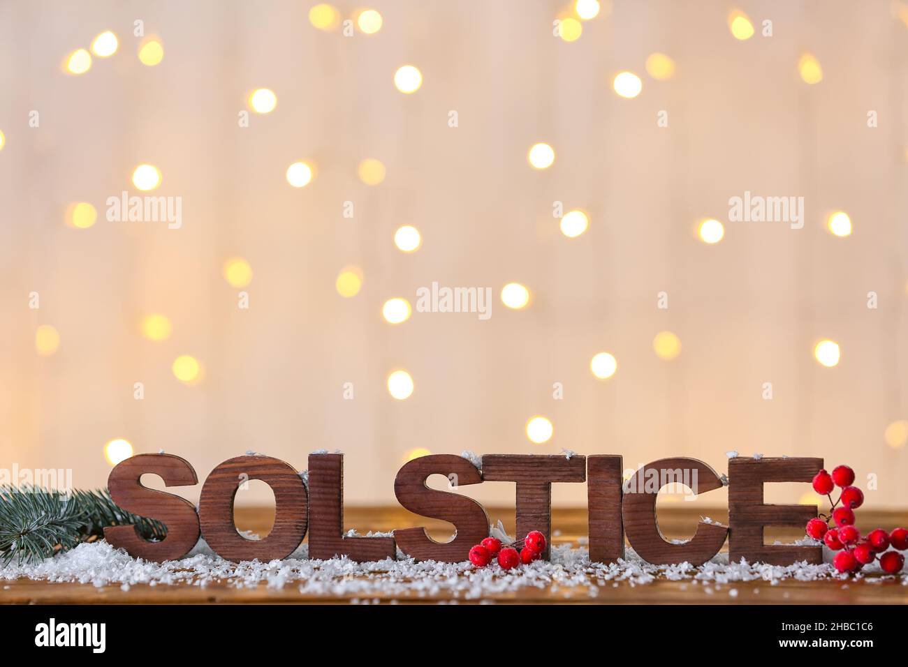 Word SOLSTICE and snow on light background with blurred lights Stock ...