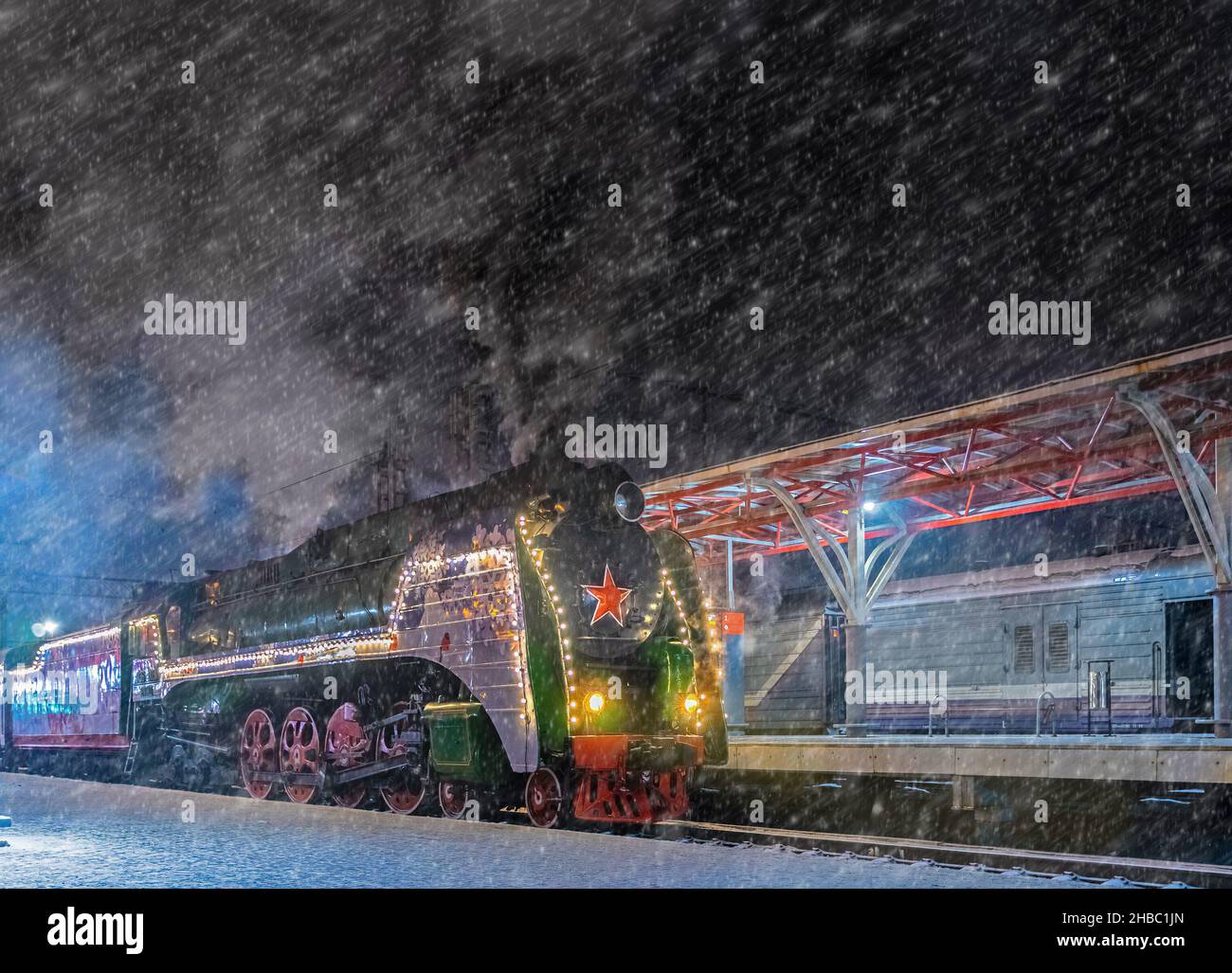 Old steam train in the snow. Vintage train decorated for the Christmas ...