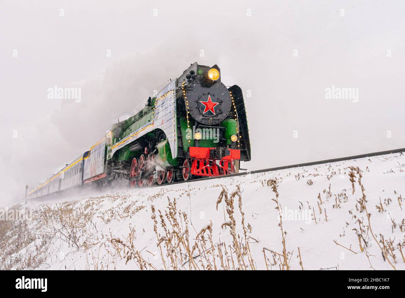 Old steam train in the snow. Vintage train decorated for the Christmas ...