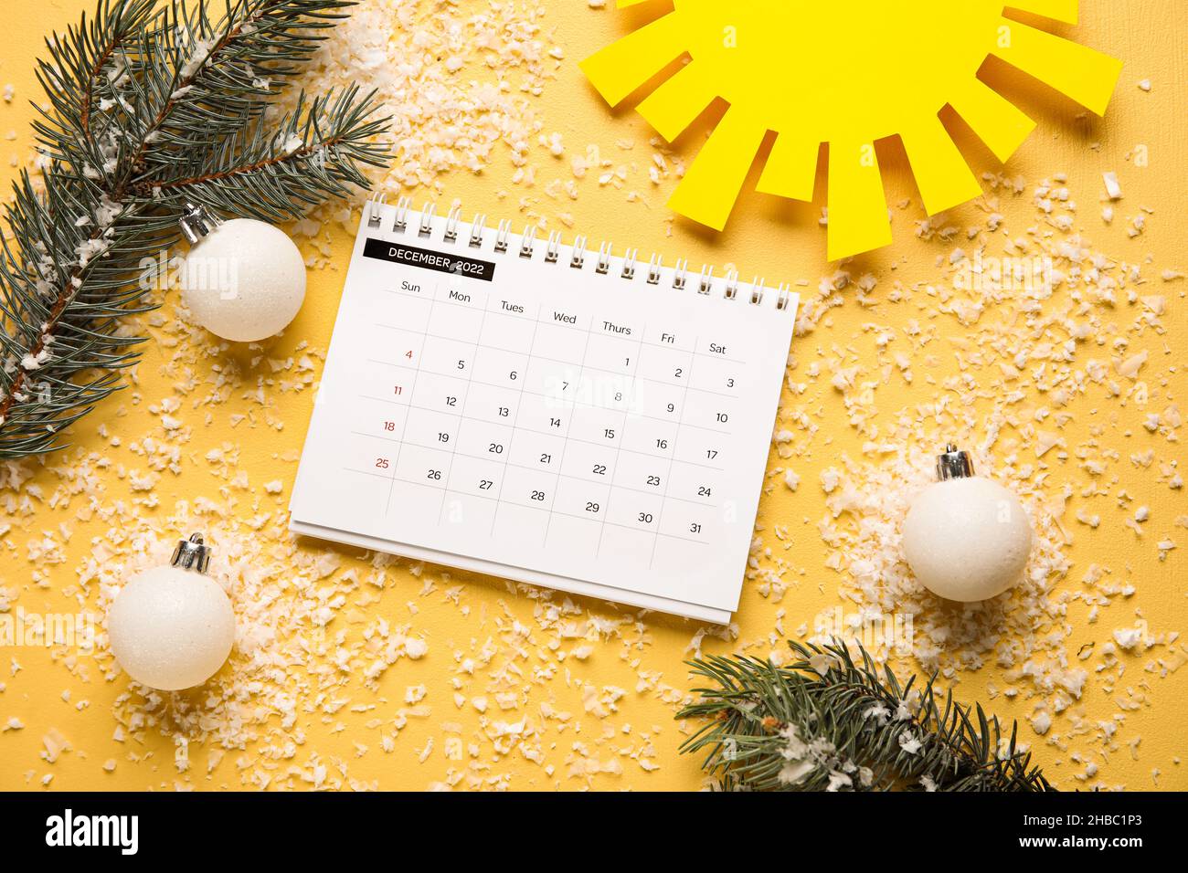Calendar with date of winter solstice and decorations on color ...