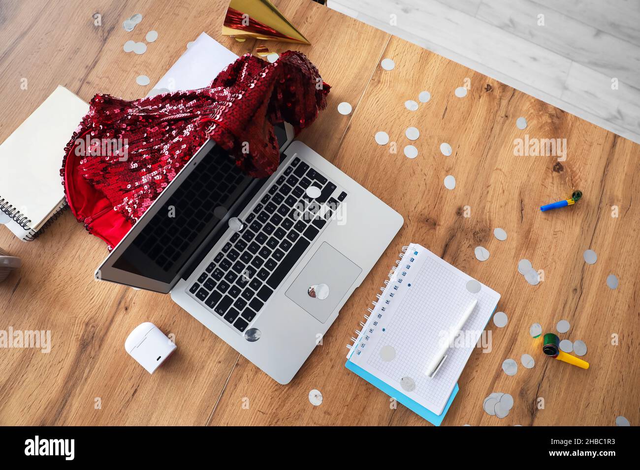 Laptop on messy table after party Stock Photo - Alamy