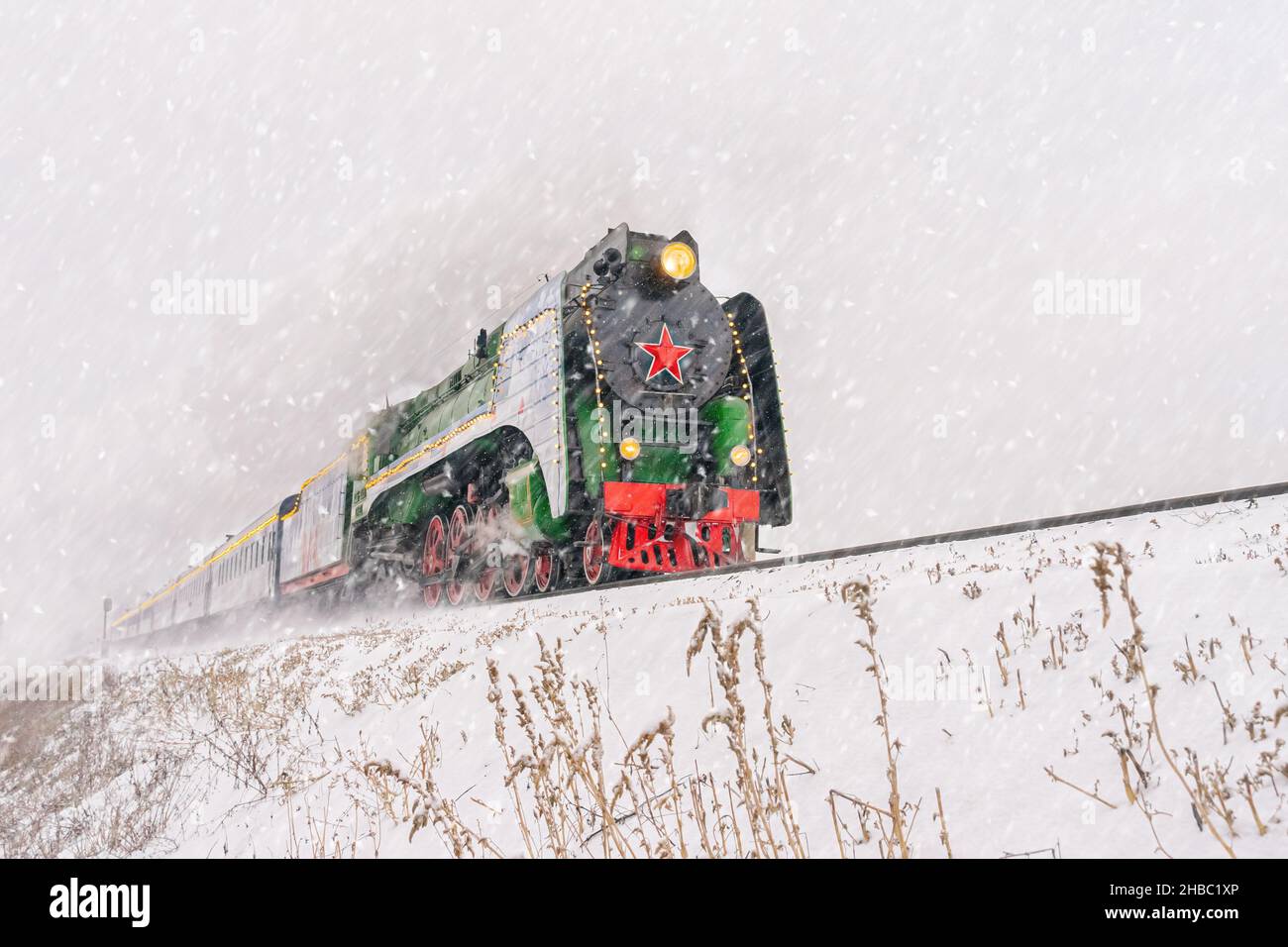 Old steam train in the snow. Vintage train decorated for the Christmas ...