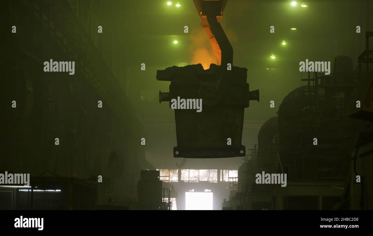 View inside of metallurgical shop with grean glow and big vat with ...