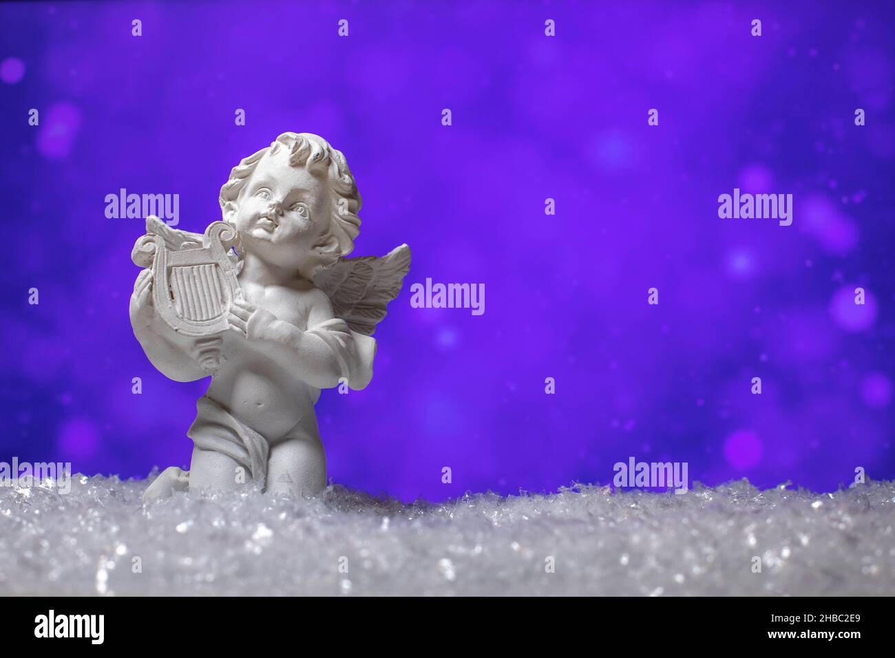 Ceramic angel statue standing on snow Stock Photo - Alamy