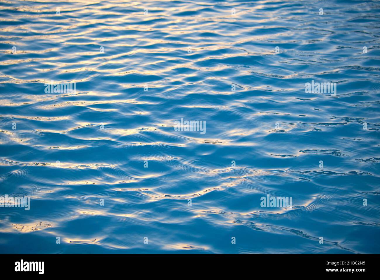 Closeup seascape surface of blue sea water with small ripple waves ...