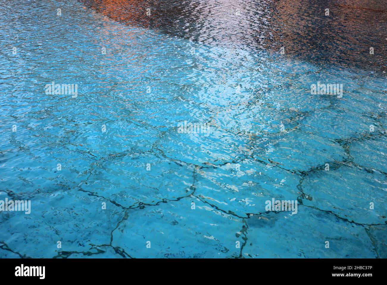 Turquoise blue bottom of a fountain full of water photographed during ...
