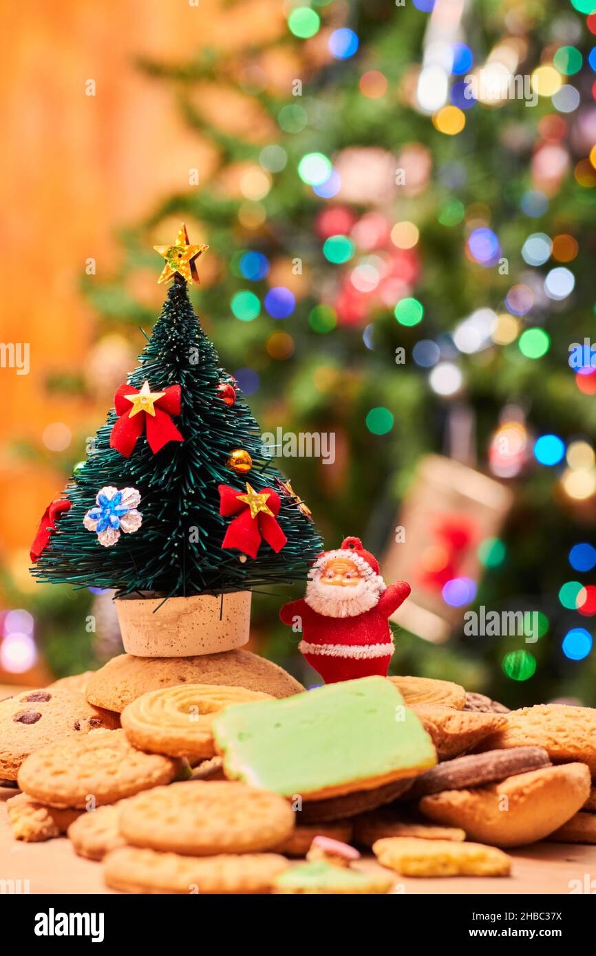 Vertical shot of Christmas ornaments on cookies with the Christmas tree ...