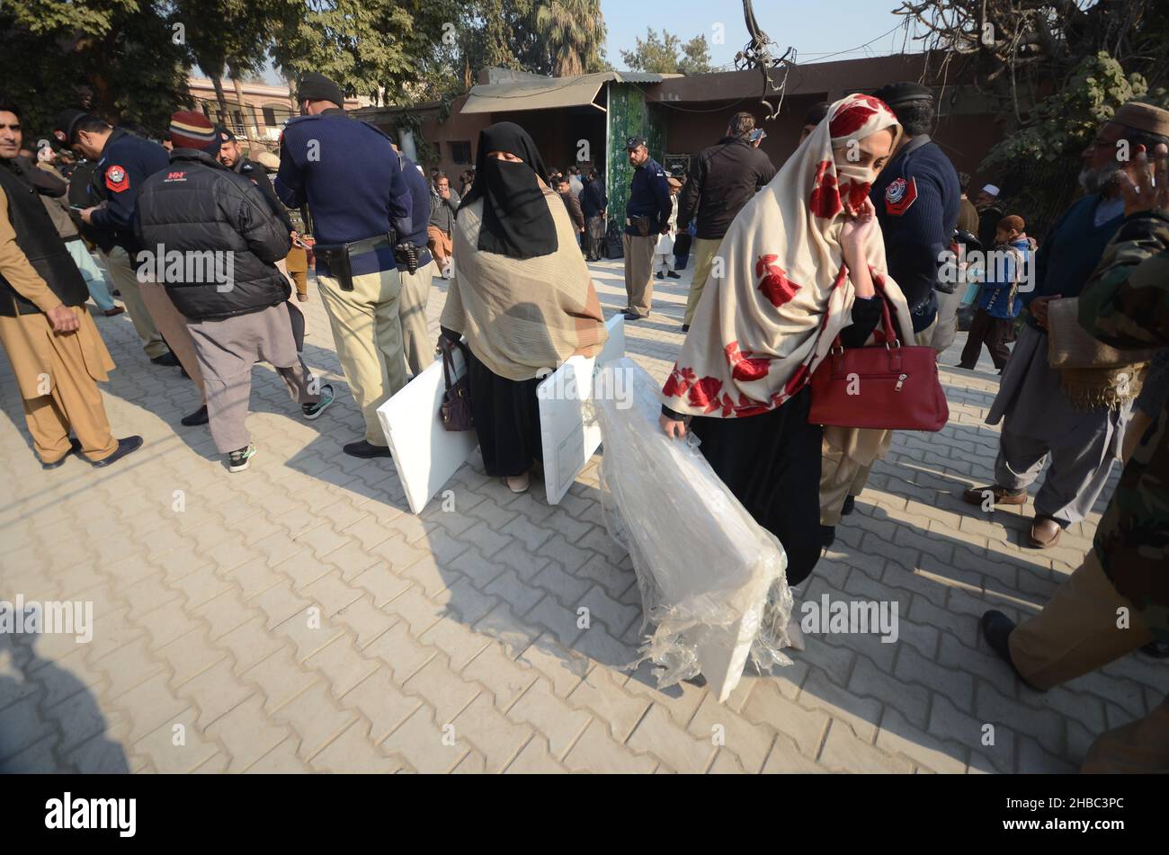 Peshawar, Pakistan. 18th Dec, 2021. A presiding officer carries a ...