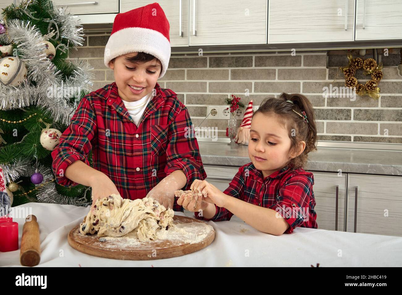 Adorable handsome children cooking together in the home kitchen during ...