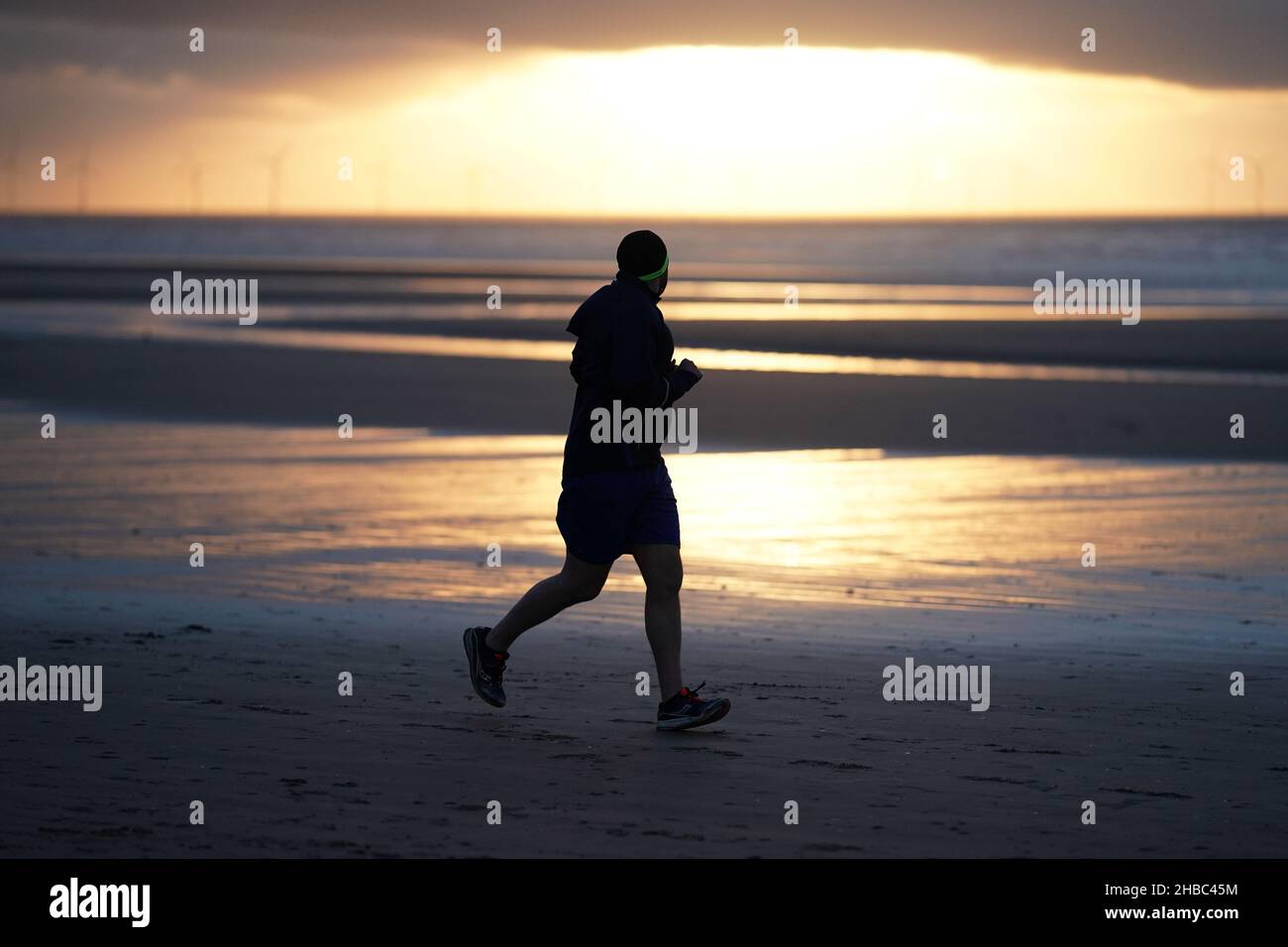 Winter sunset at Formby Beach. A runner on the beach Stock Photo - Alamy