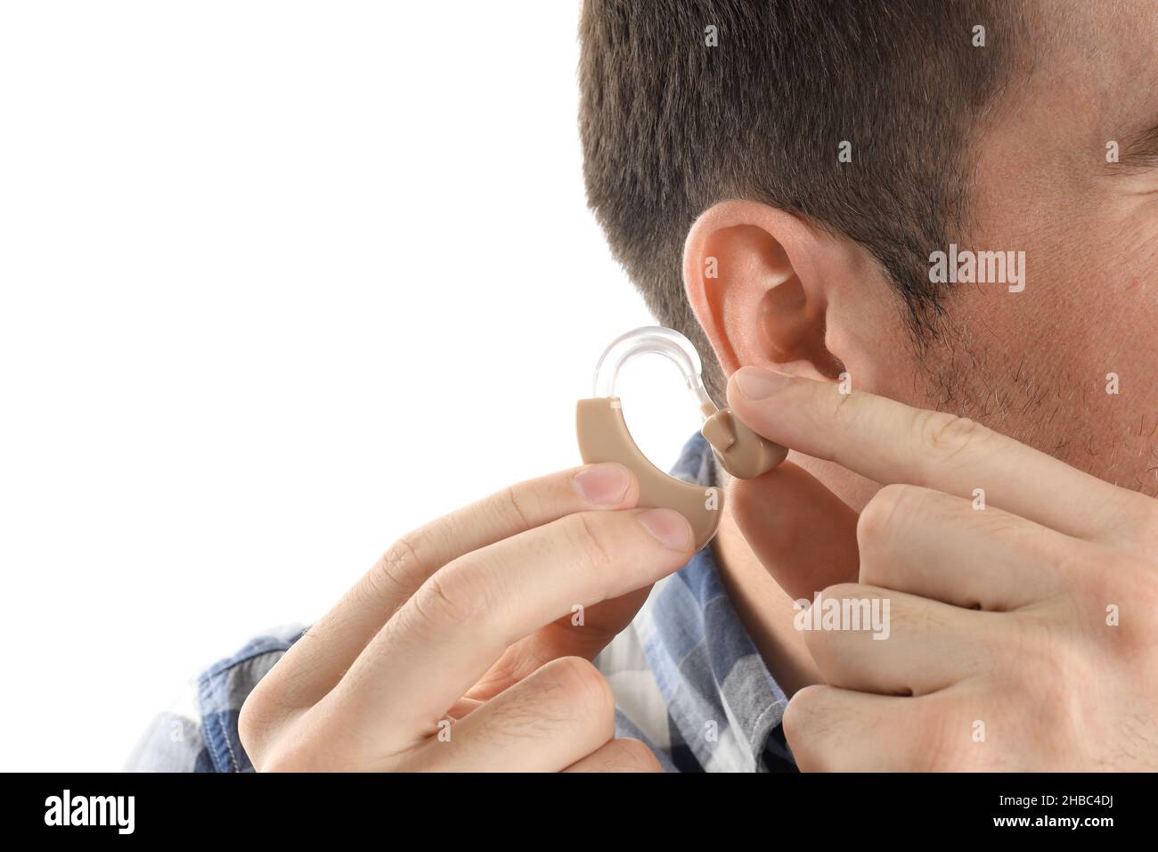 Young man install hearing aid, isolated on white background Stock Photo ...
