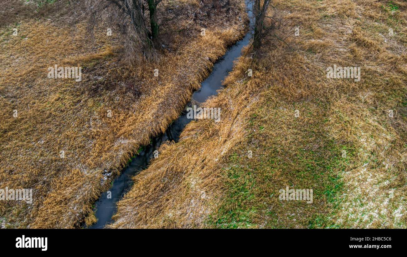 Autumn field and meadows with small stream Stock Photo - Alamy