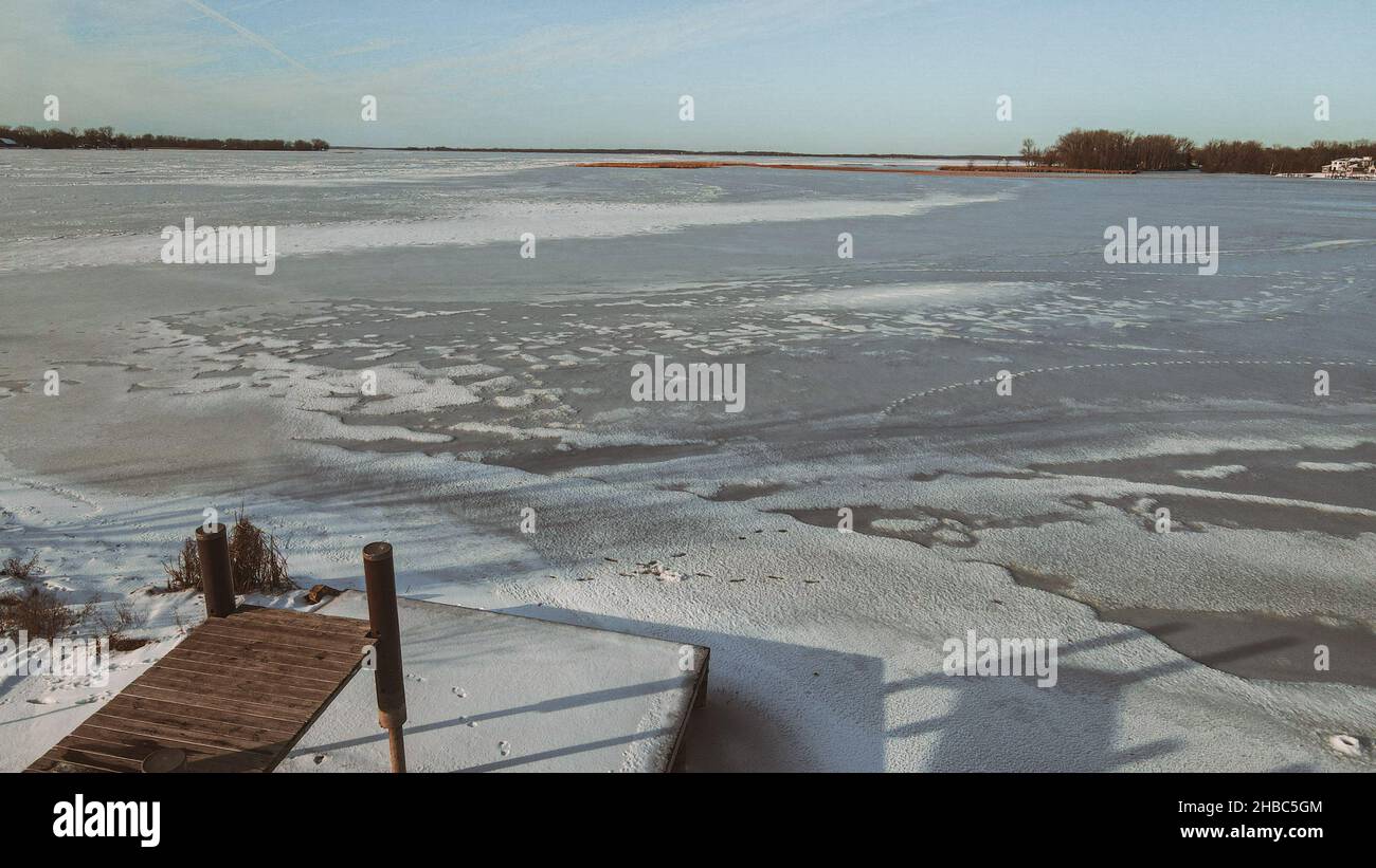 Frozen blue lake under blue sky Stock Photo - Alamy