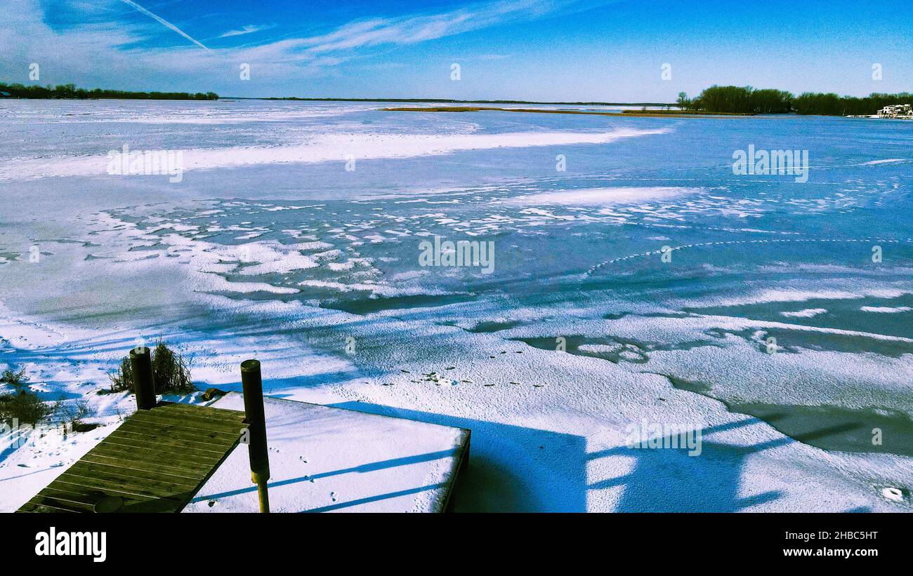 Frozen blue lake under blue sky Stock Photo - Alamy