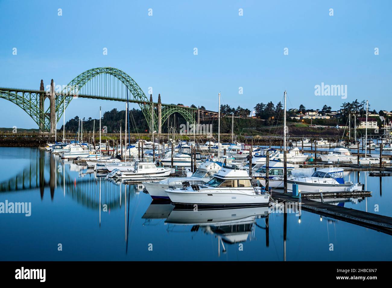 Boats moored in Port of Newport Marina and Yaquina Bay Bridge, Newport ...