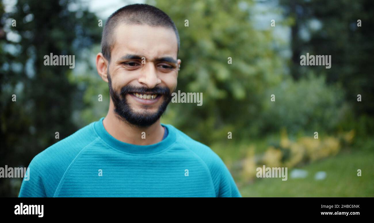 Portrait of a cheerful adult Indian man having a conversation in a ...