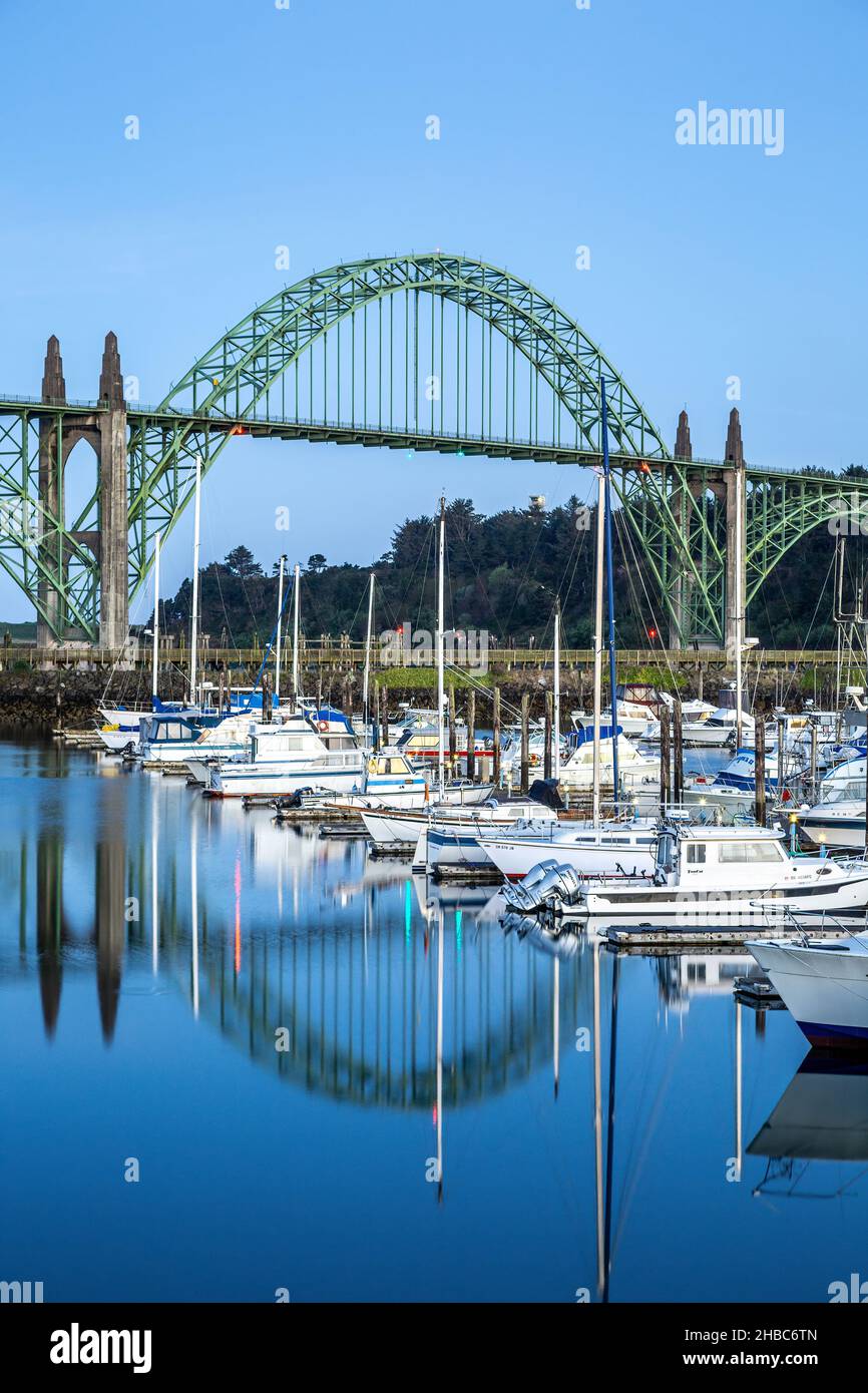 Boats moored in Port of Newport Marina and Yaquina Bay Bridge, Newport ...