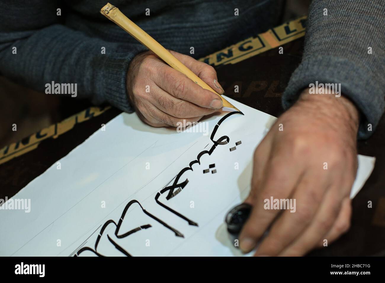 Baghdad, Iraq. 18th Dec, 2021. Iraqi Arabic calligraphy master Amin ...